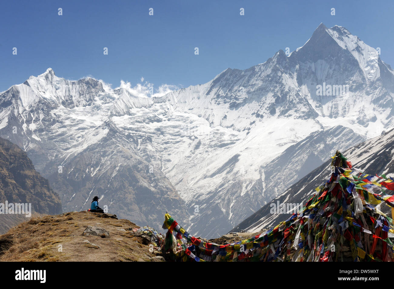 A lady trekker sitting admiring the huge landscape in the Annapurna ...