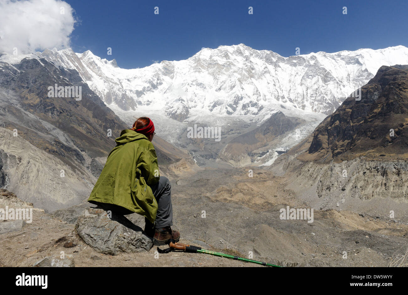 A lady trekker sitting admiring the huge landscape in the Annapurna ...