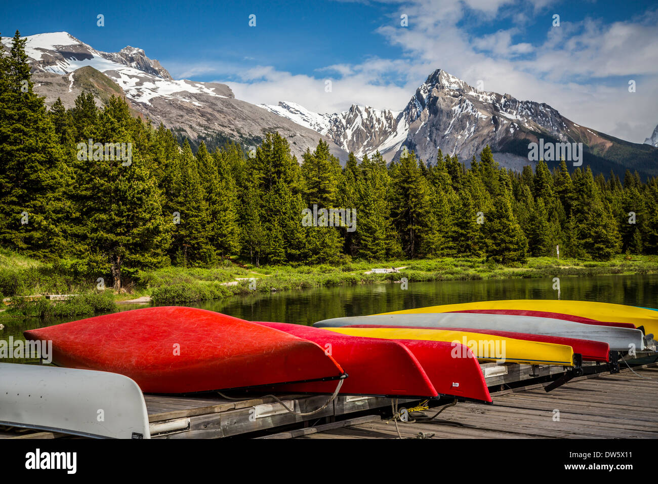 Colorful canoes at the dock at the Maligne Lake boat dock in Jasper ...