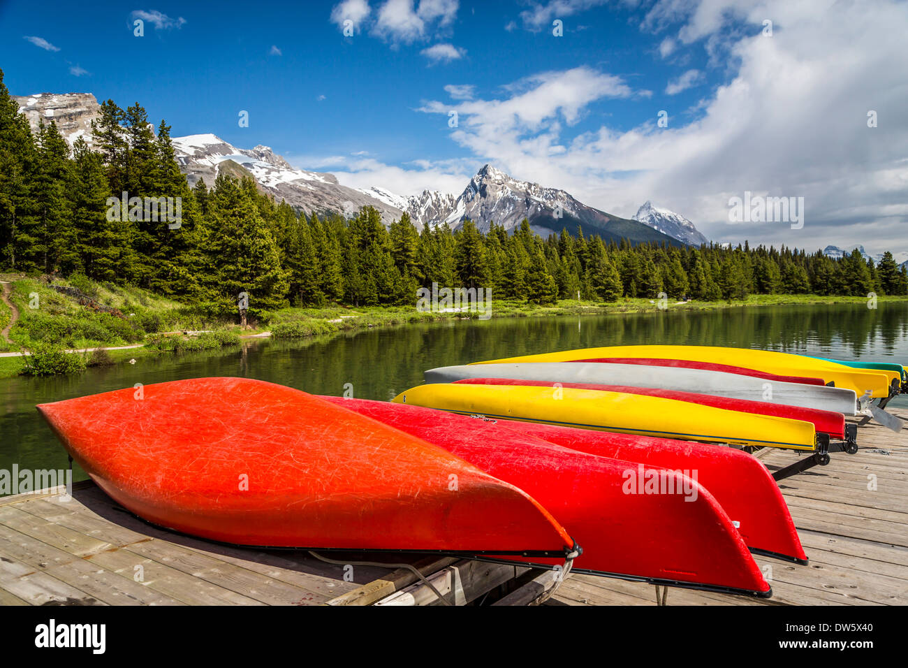 Colorful canoes at the dock at the Maligne Lake boat dock in Jasper ...