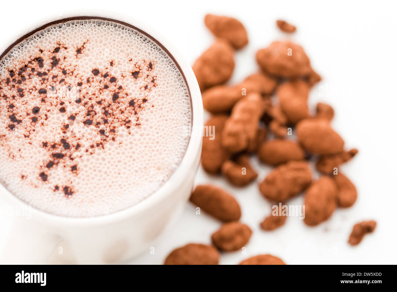 Gourmet sipping chocolate with •chocolate covered cacao beans on a ...