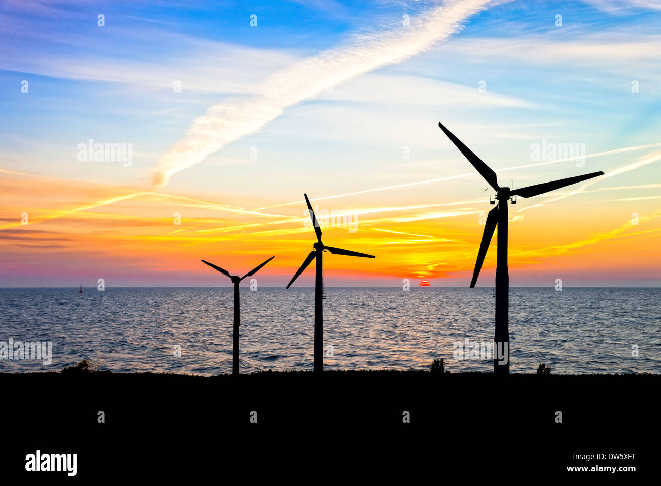 Wind power and colorful sunset over the sea Stock Photo - Alamy