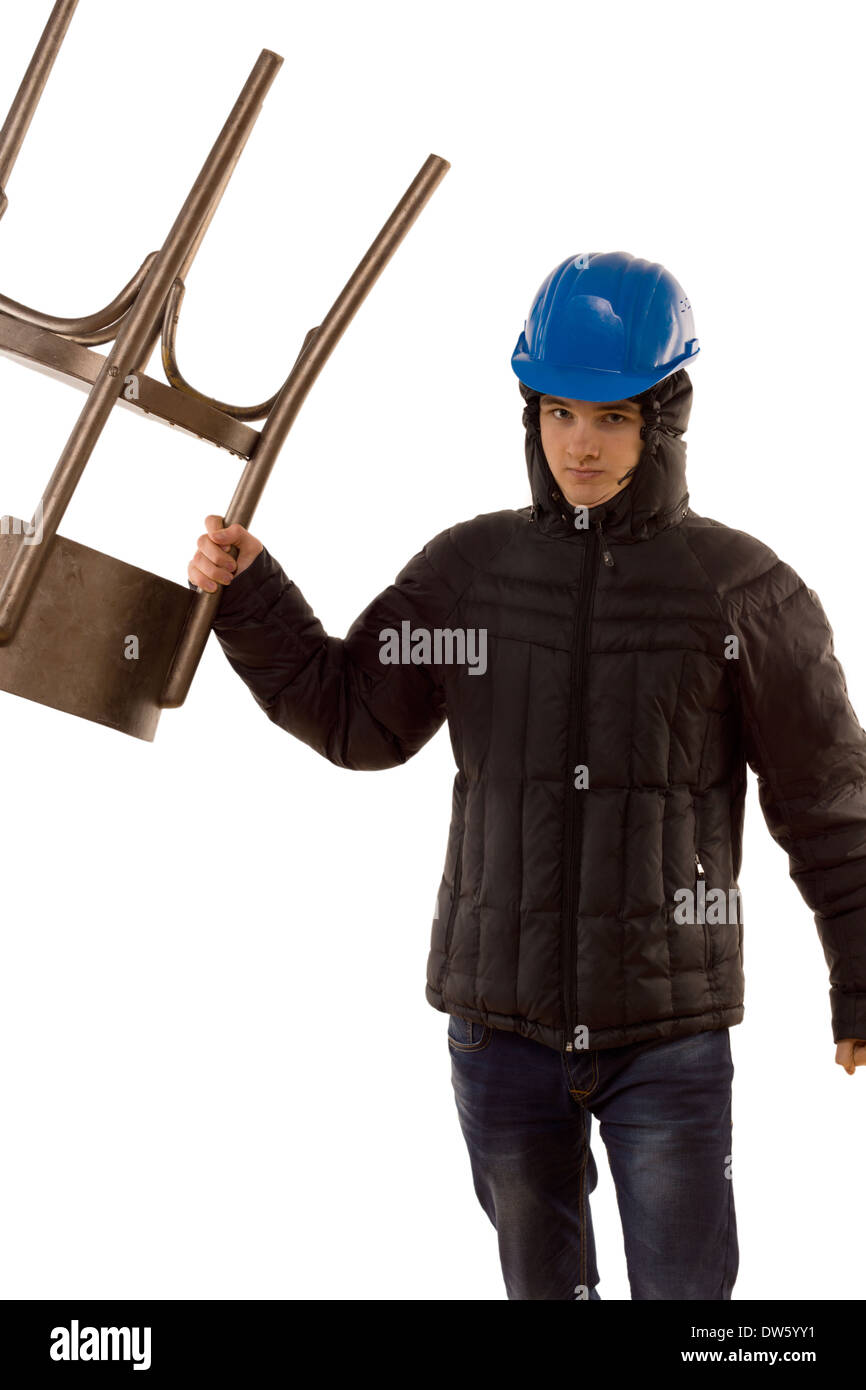 Young male thug in a balaclava and hardhat standing raising his arm ...