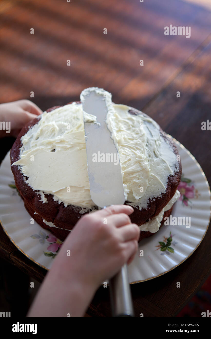 Boy decorating cake hi-res stock photography and images - Alamy