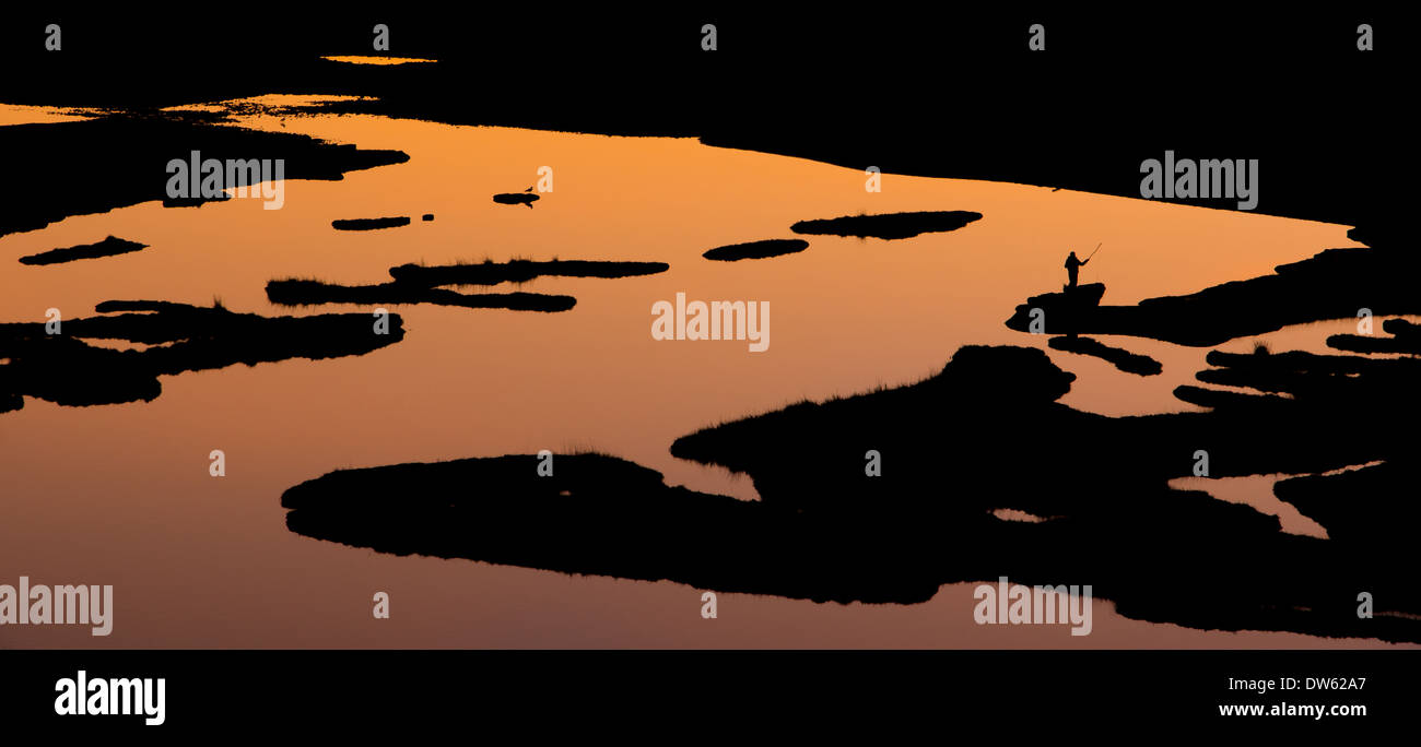 Lone sunset walker Stock Photo - Alamy