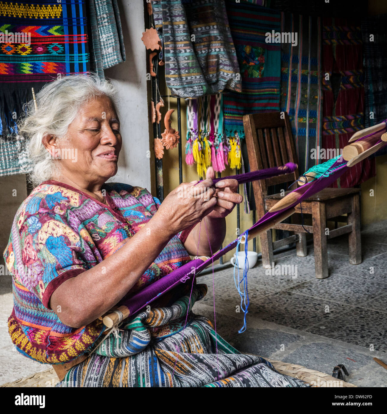 Old woman in Antigua weaves traditional cloth, Guatemala Stock Photo ...