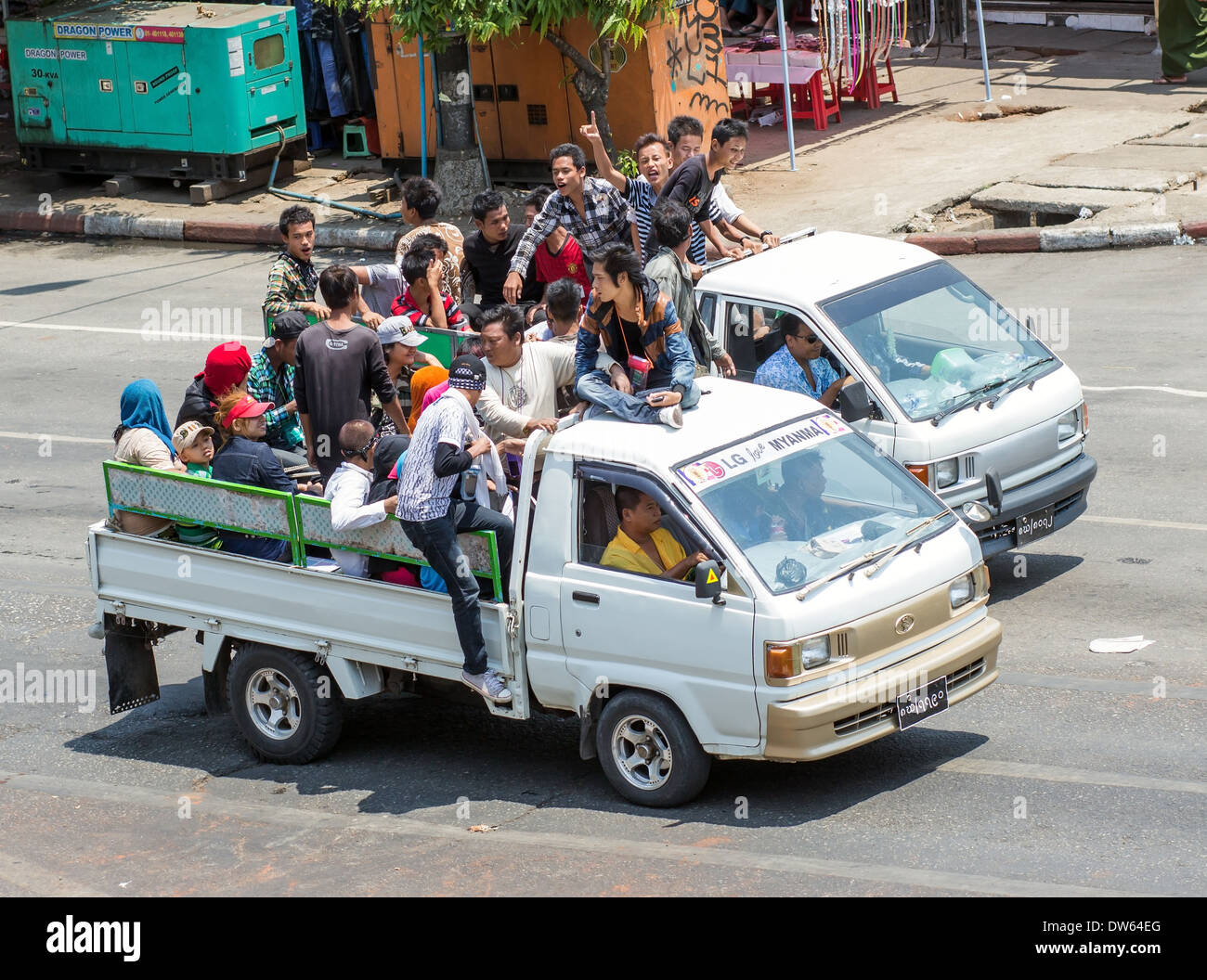 cheerful people riding on a lorry Stock Photo - Alamy
