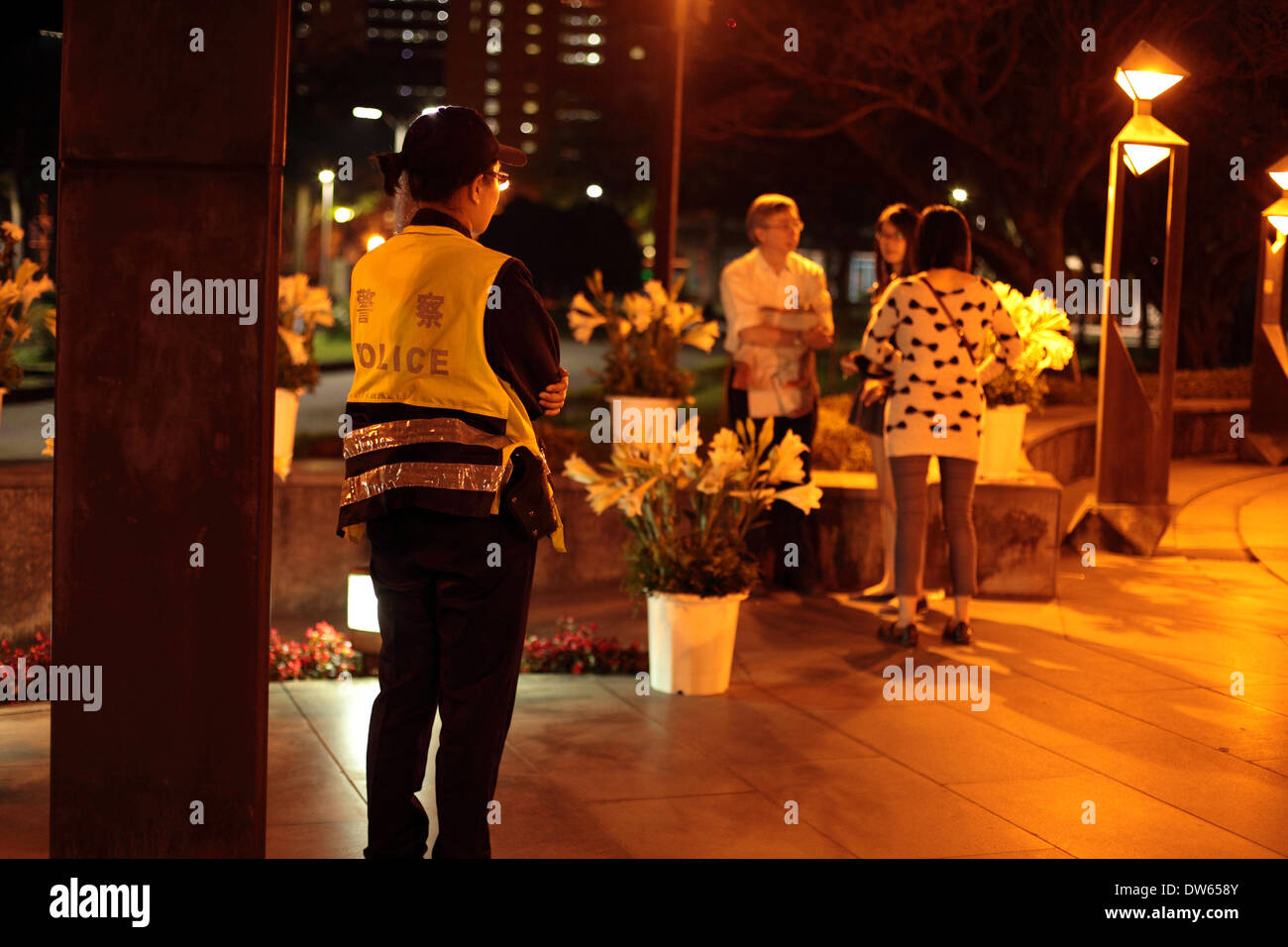 Taipei, Taiwan- February 28, 2014: Park at night with police watching ...