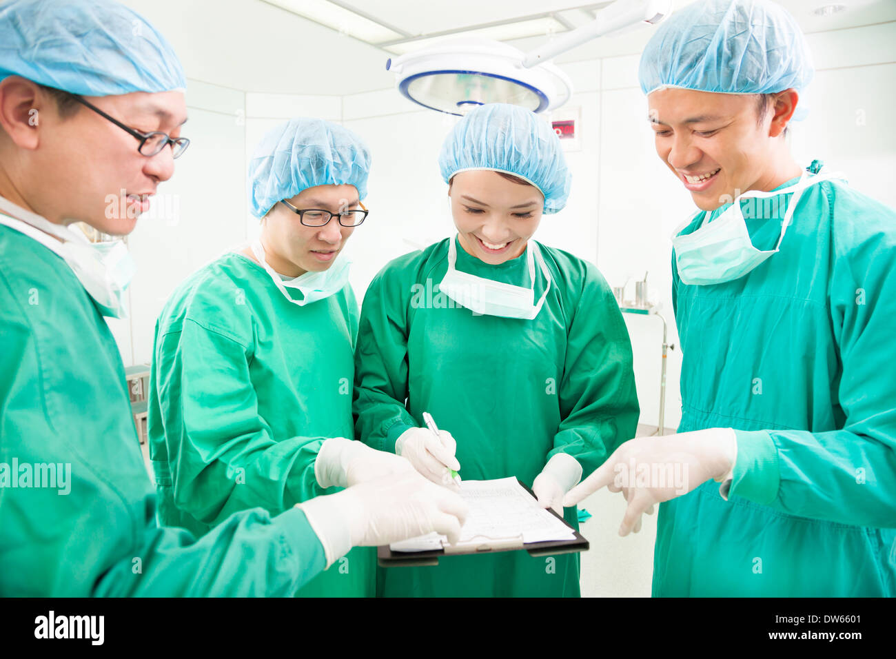 happy Surgeons discussing success operating procedure in operation room ...
