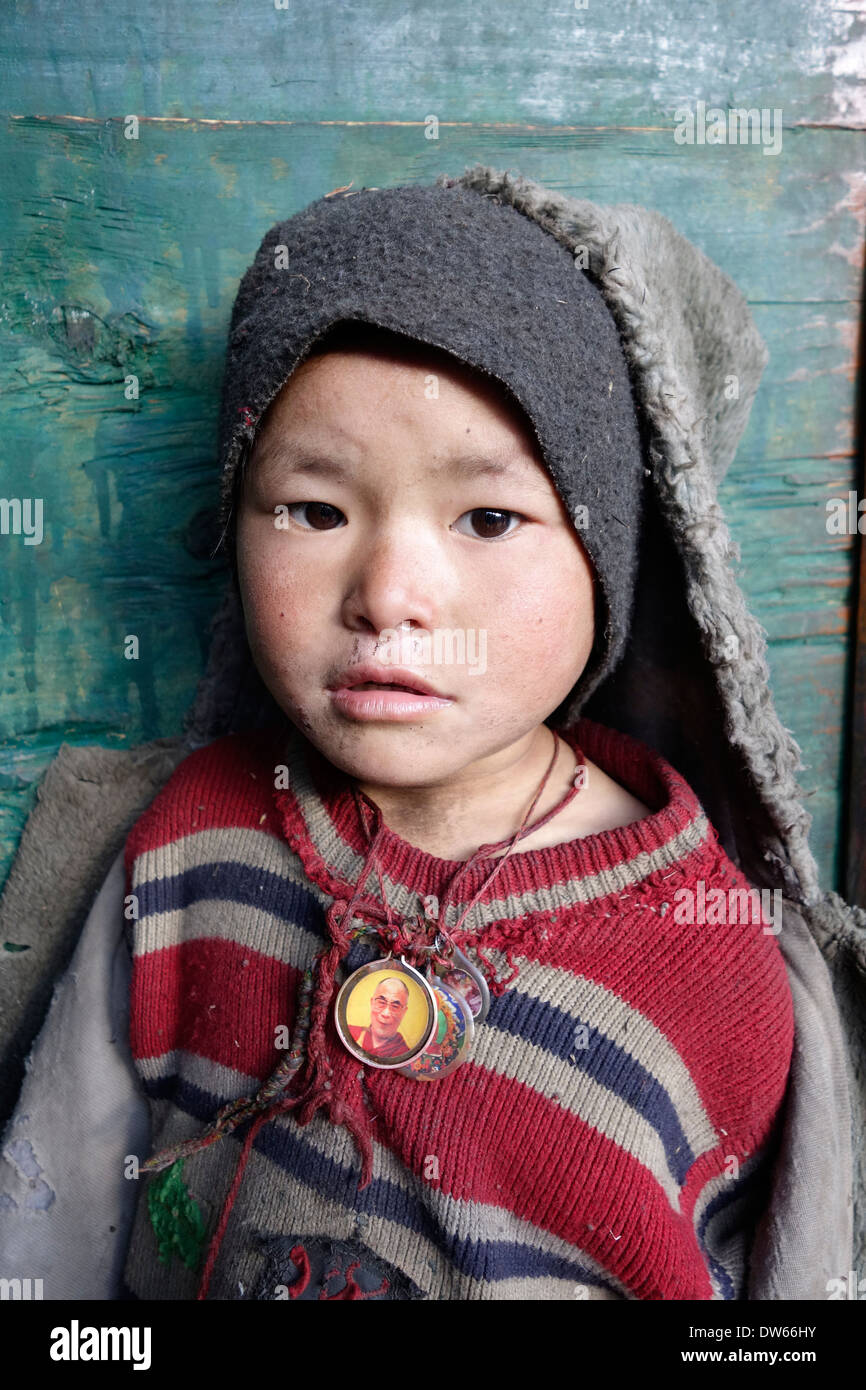 Boy wearing a Dalai Lama pendant in the Tsum Valley of Nepal Stock ...