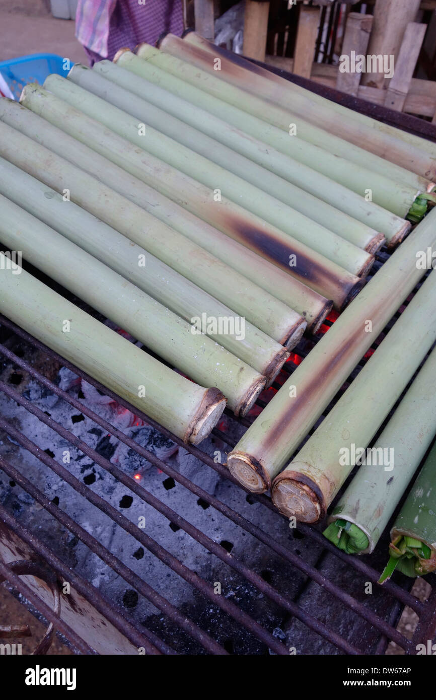 Cooking sticky rice in bamboo at a market in Tha Ton, Thailand Stock ...