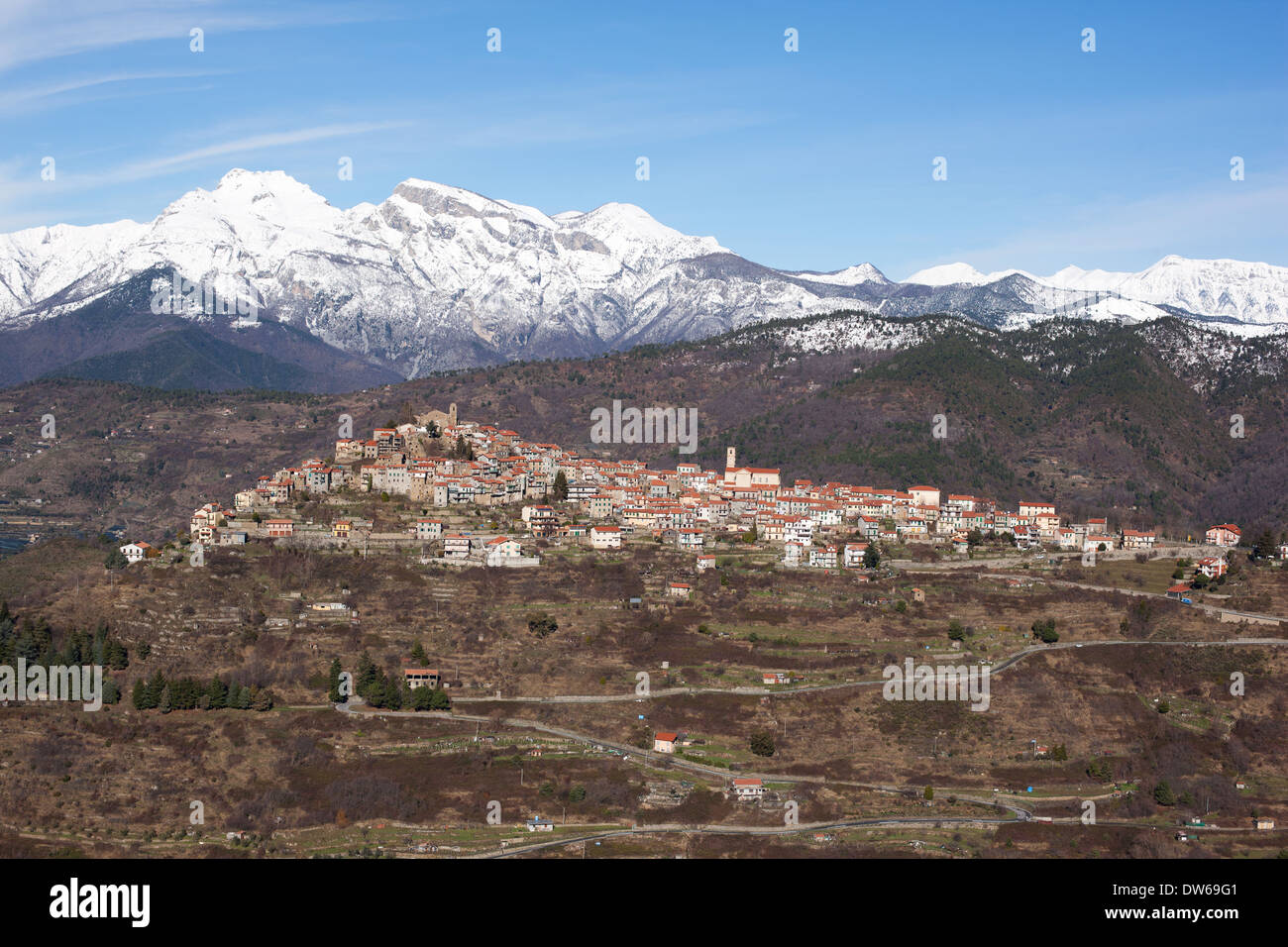 AERIAL VIEW. Perched medieval village with the snowcapped Alps on the ...