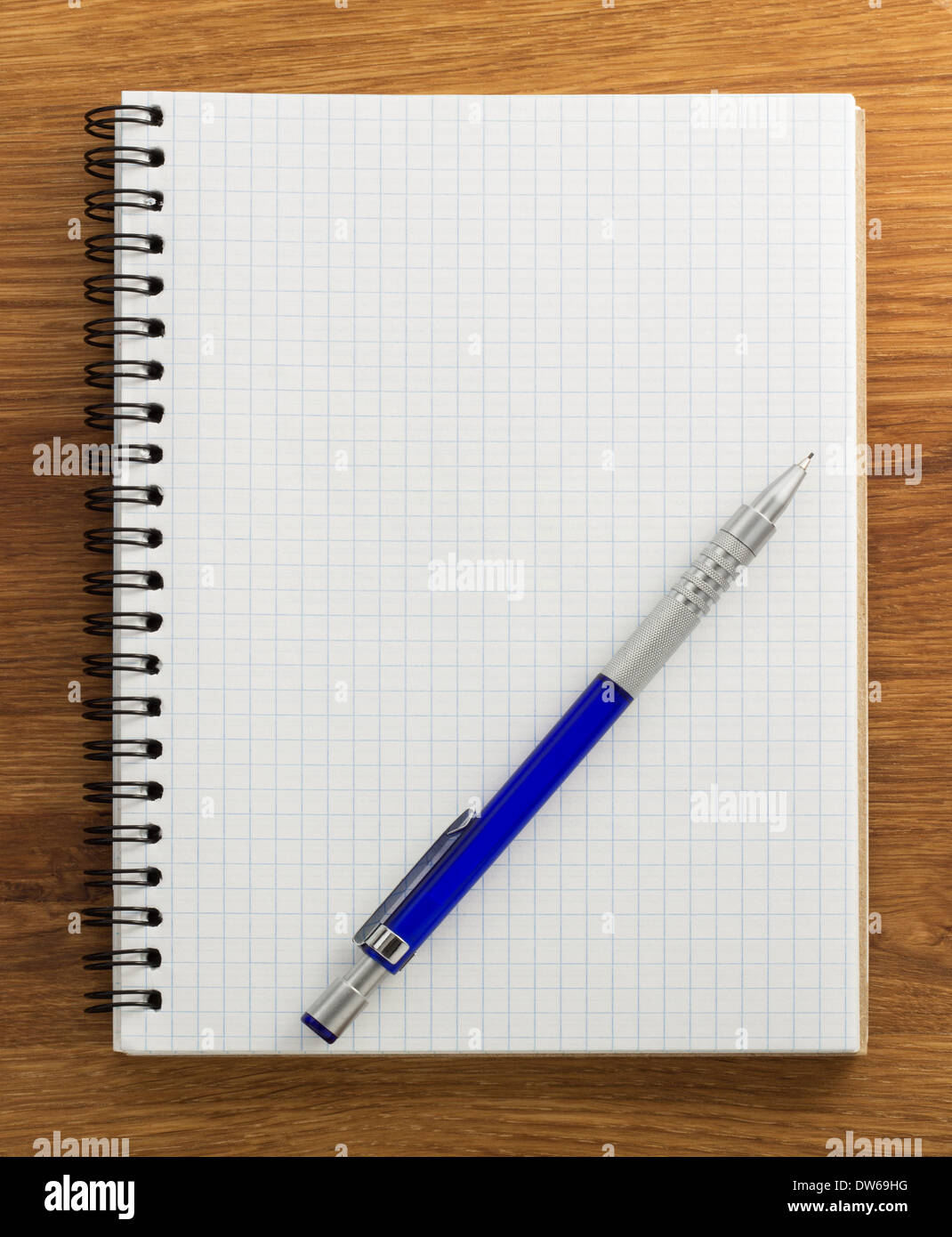 checked notebook on wood background Stock Photo - Alamy