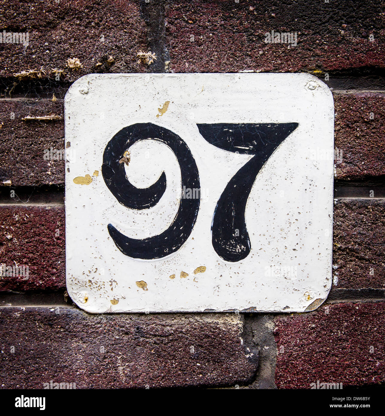 hand painted house number ninety seven. Black lettering on a white ...