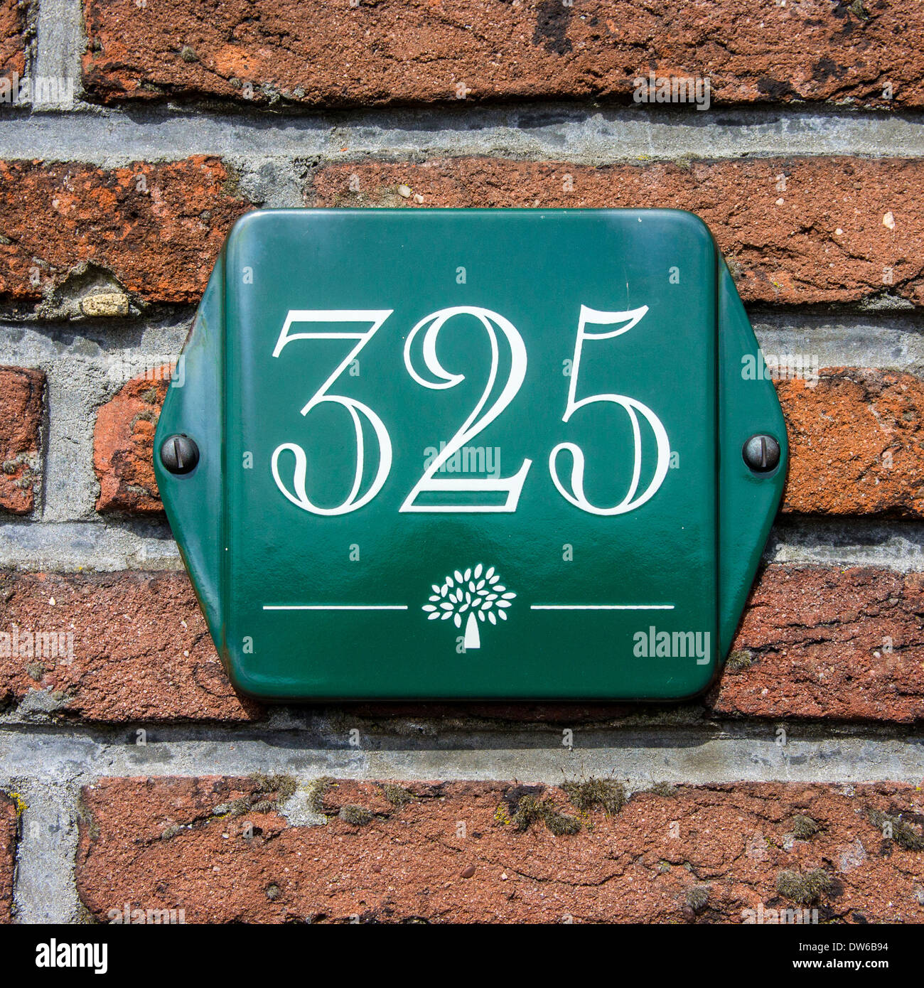 enameled house number three hundred and twenty-five atop a small tree ...