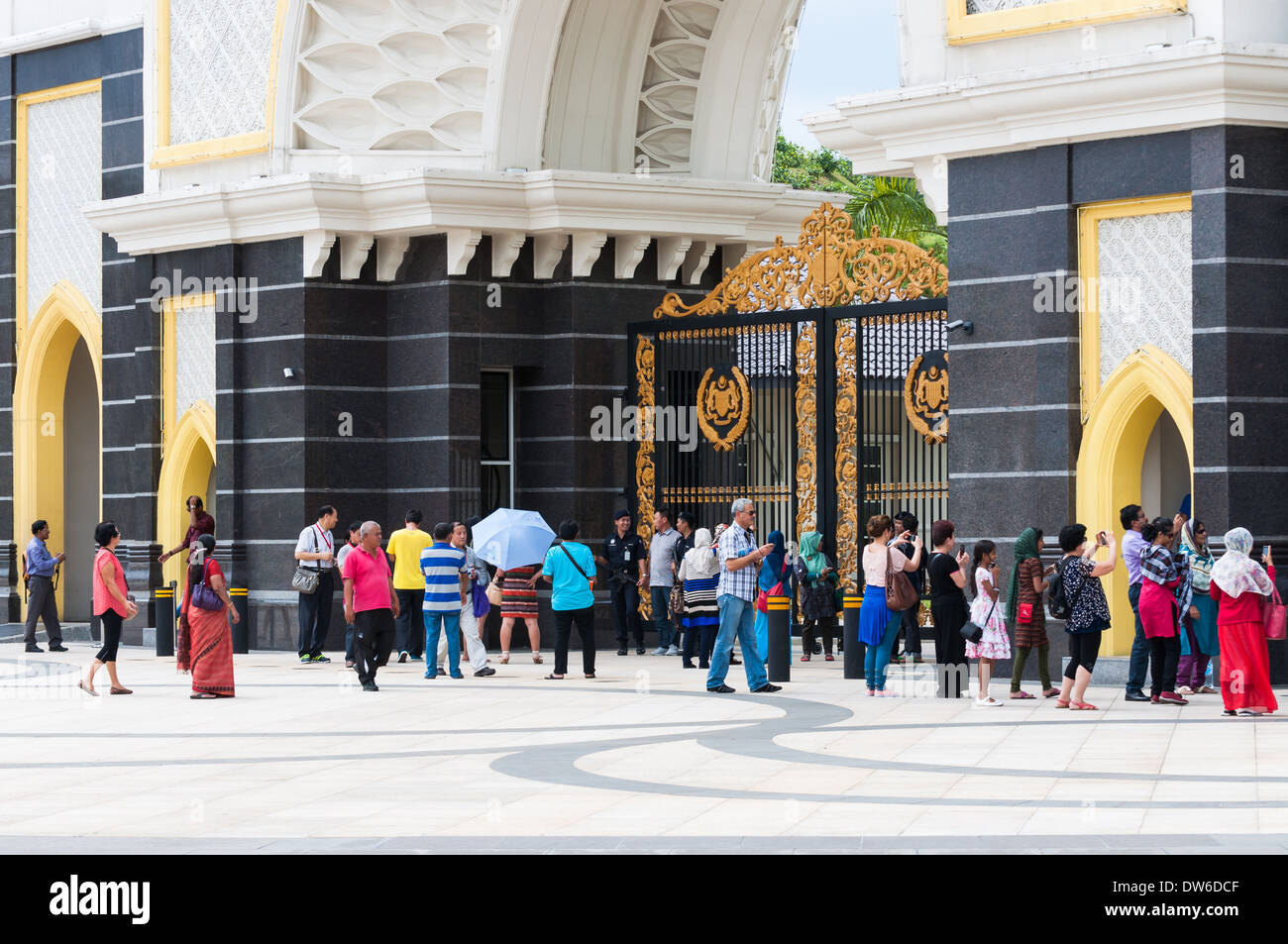 Tourists outside the massive front gate of the Istana Negara, the royal ...