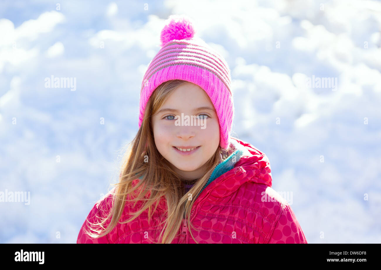 Blond kid girl winter pink hat in the snow smiling happy Stock Photo ...