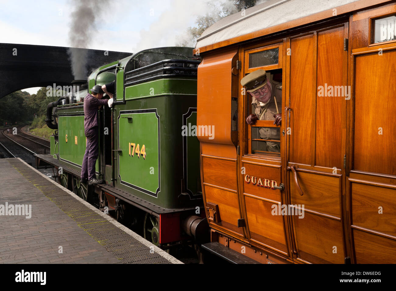 A Soldier wearing a 1940's Captain's uniform looks out from a railway ...