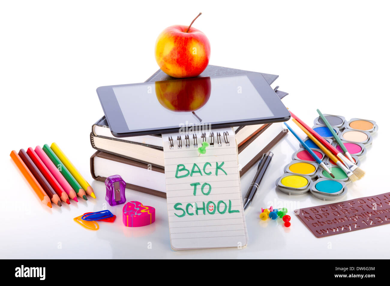 Mini digital tablet with school accessories on white background Stock ...