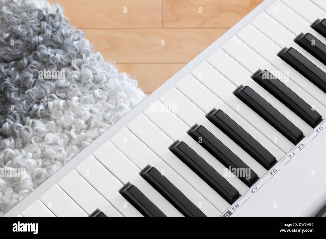 Close-up of electric piano keys and chair Stock Photo - Alamy