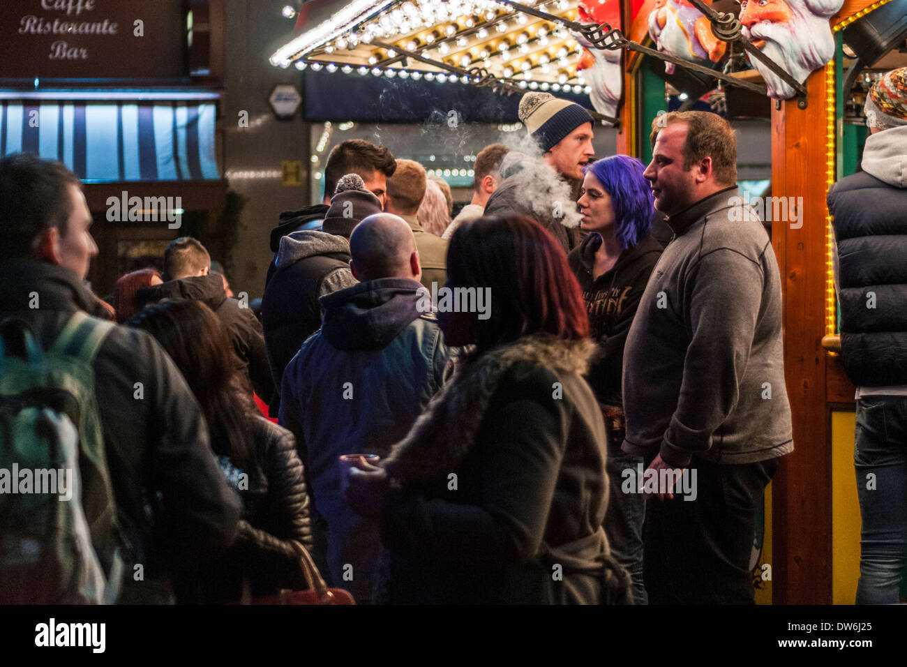 People standing around a beer stall at a German Market in Birmingham ...