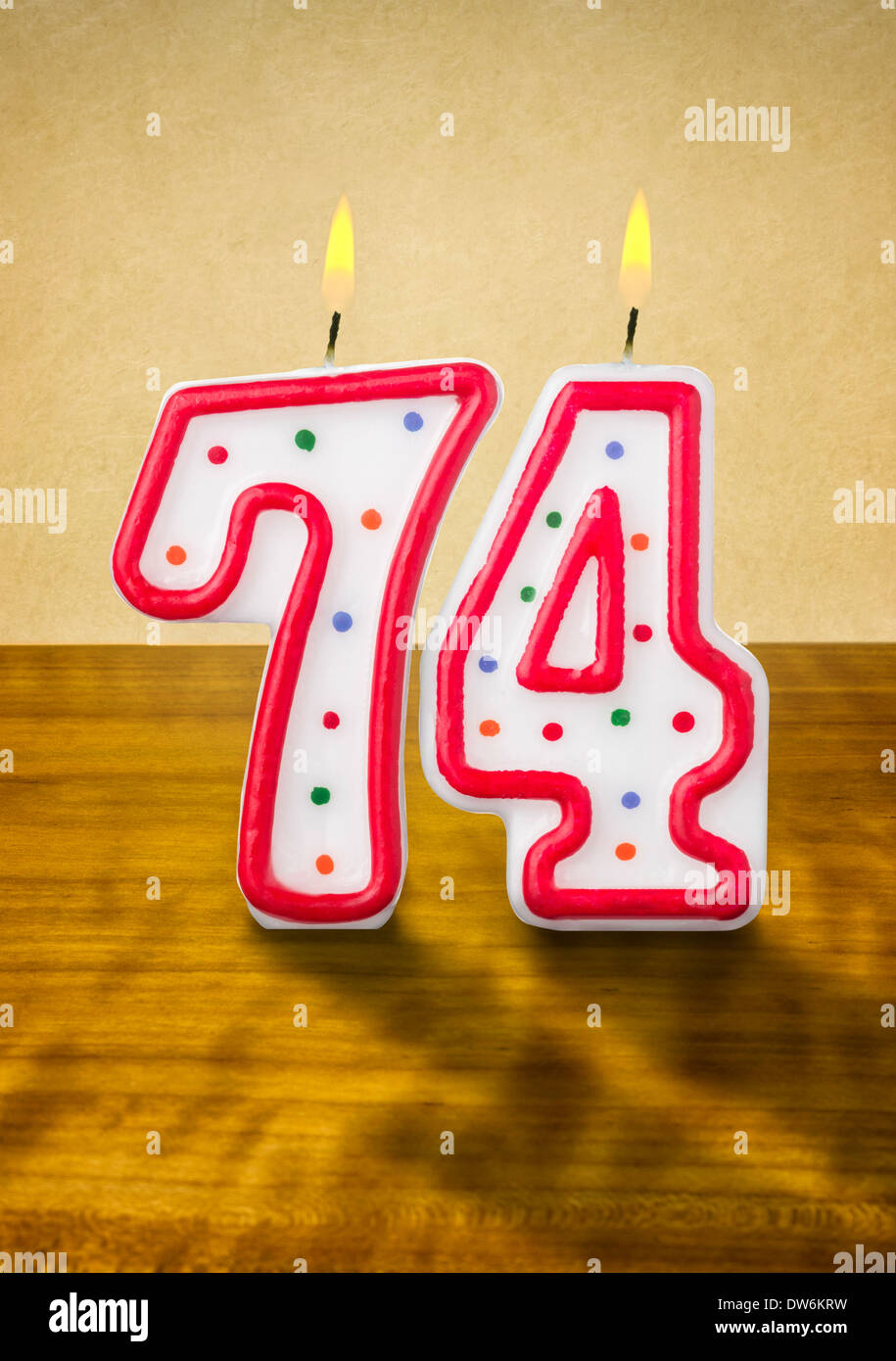 Burning birthday candles number 74 Stock Photo - Alamy