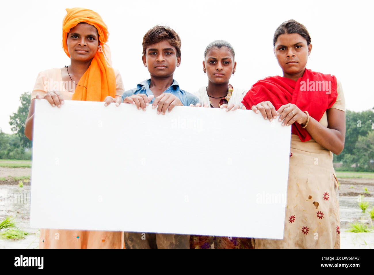 Indian villager standing with message board Stock Photo - Alamy