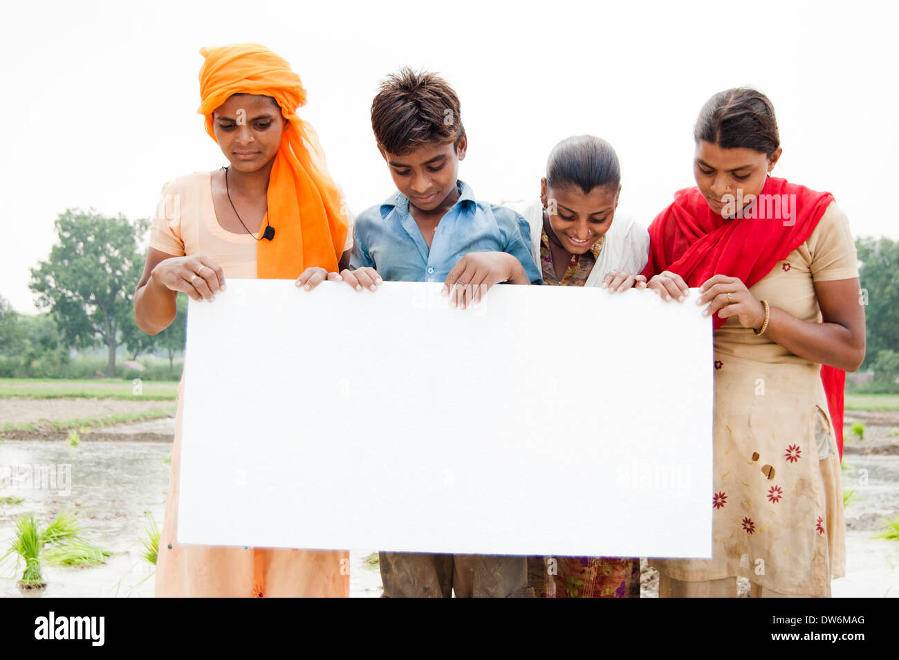 Indian villager standing with message board Stock Photo - Alamy