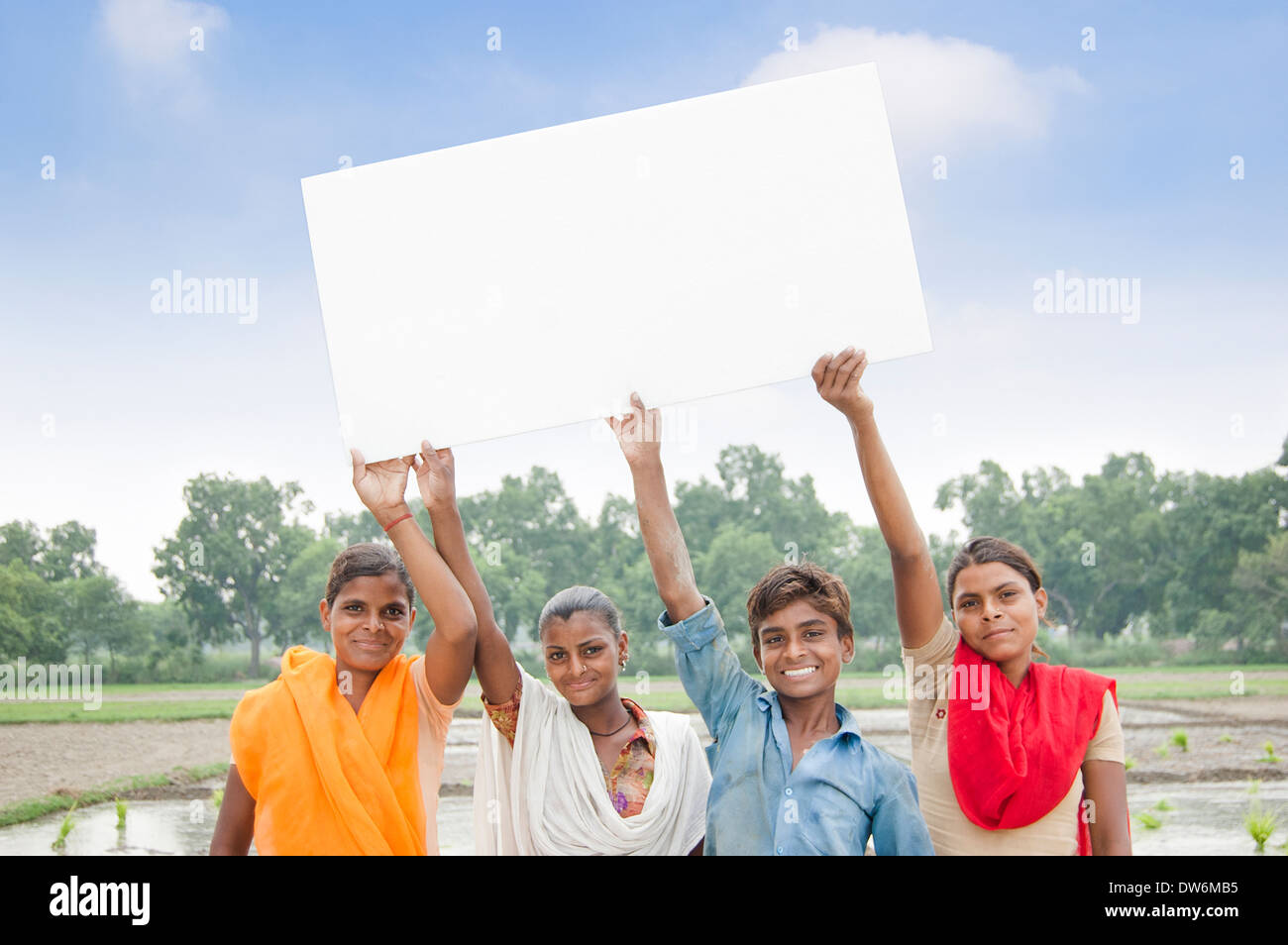 Indian villager standing with message board Stock Photo - Alamy