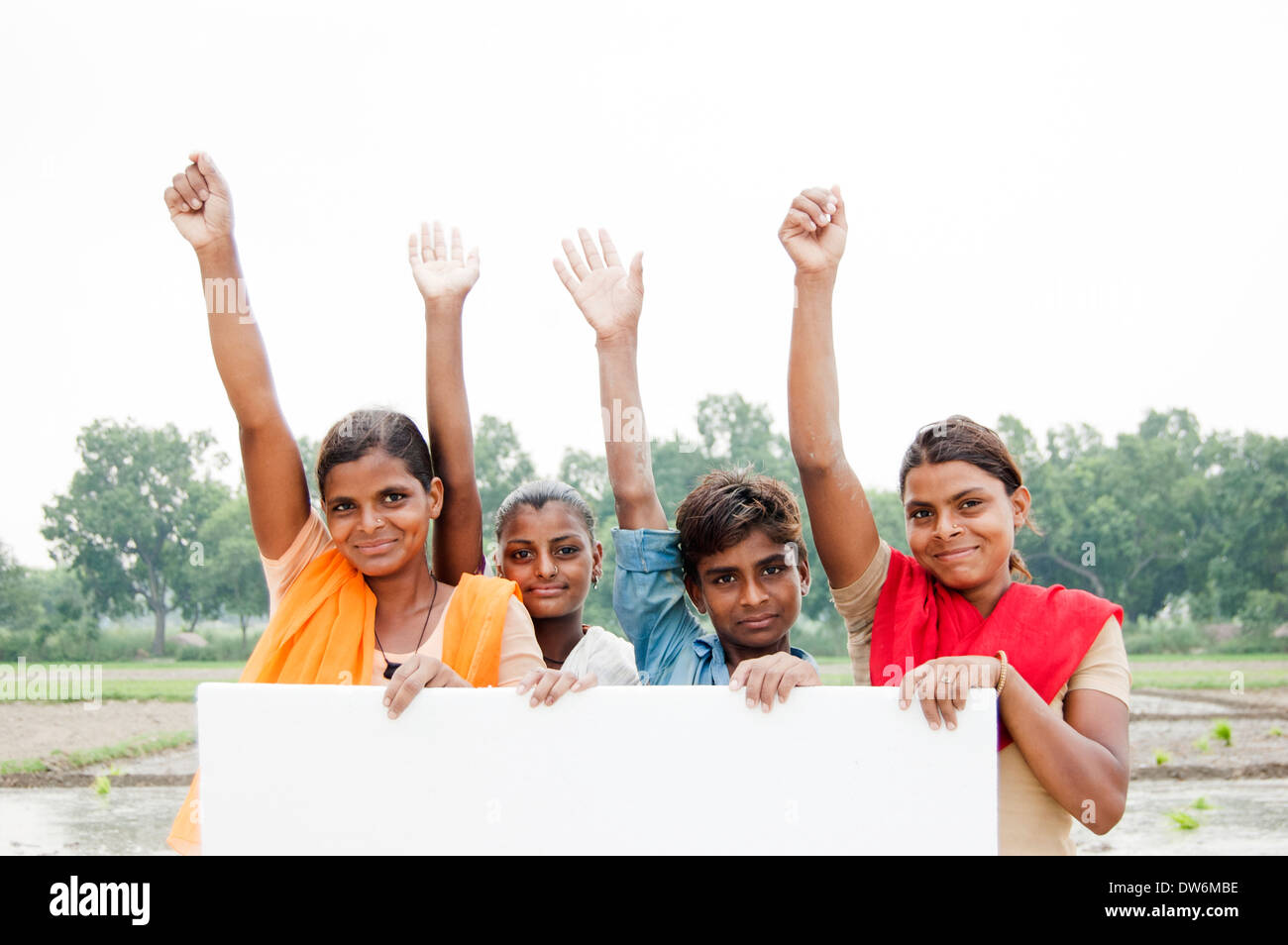 Indian villager standing with message board Stock Photo - Alamy