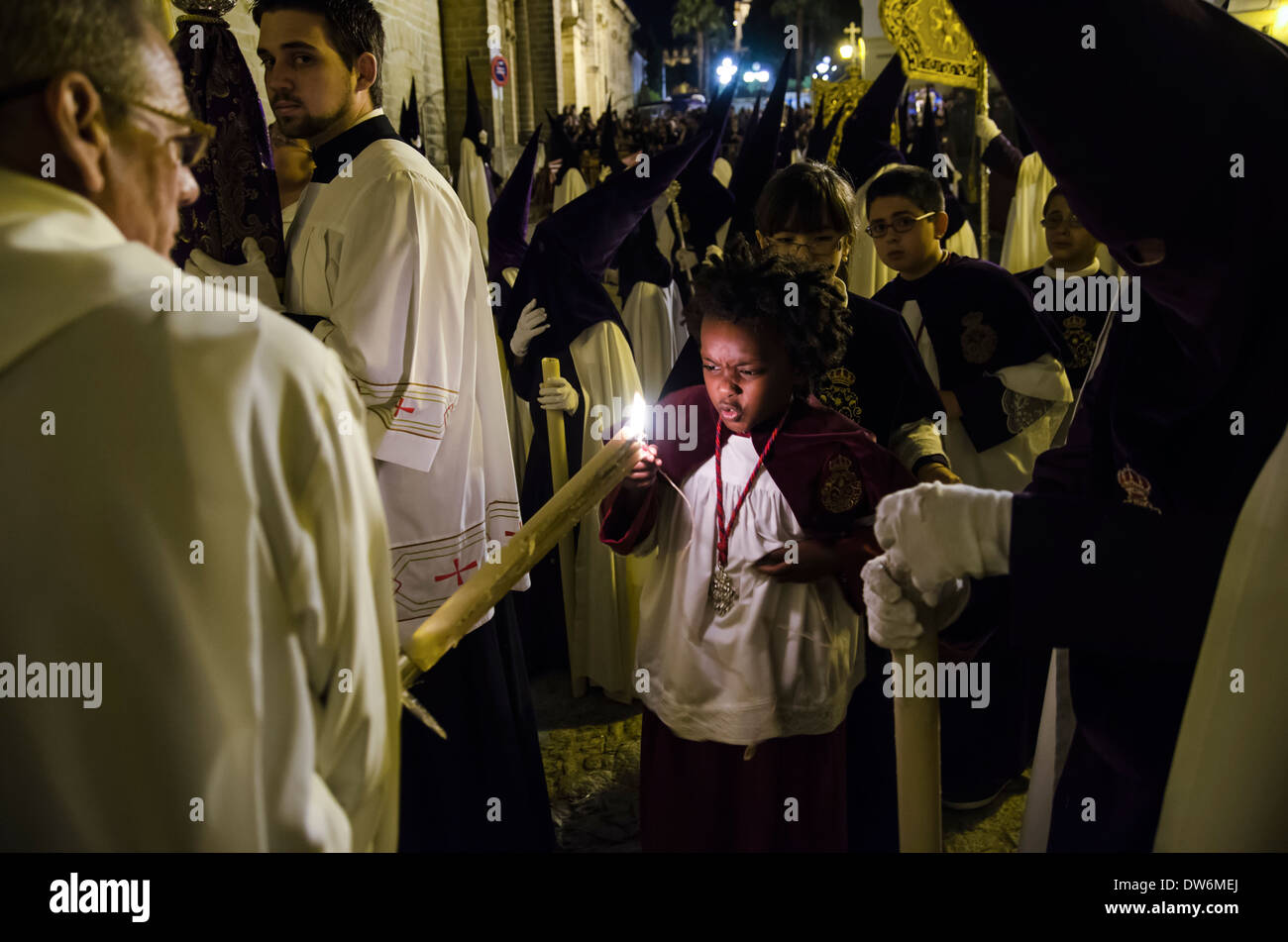 An acolyte of the brotherhood of "La Candelaria" light a candle. In ...