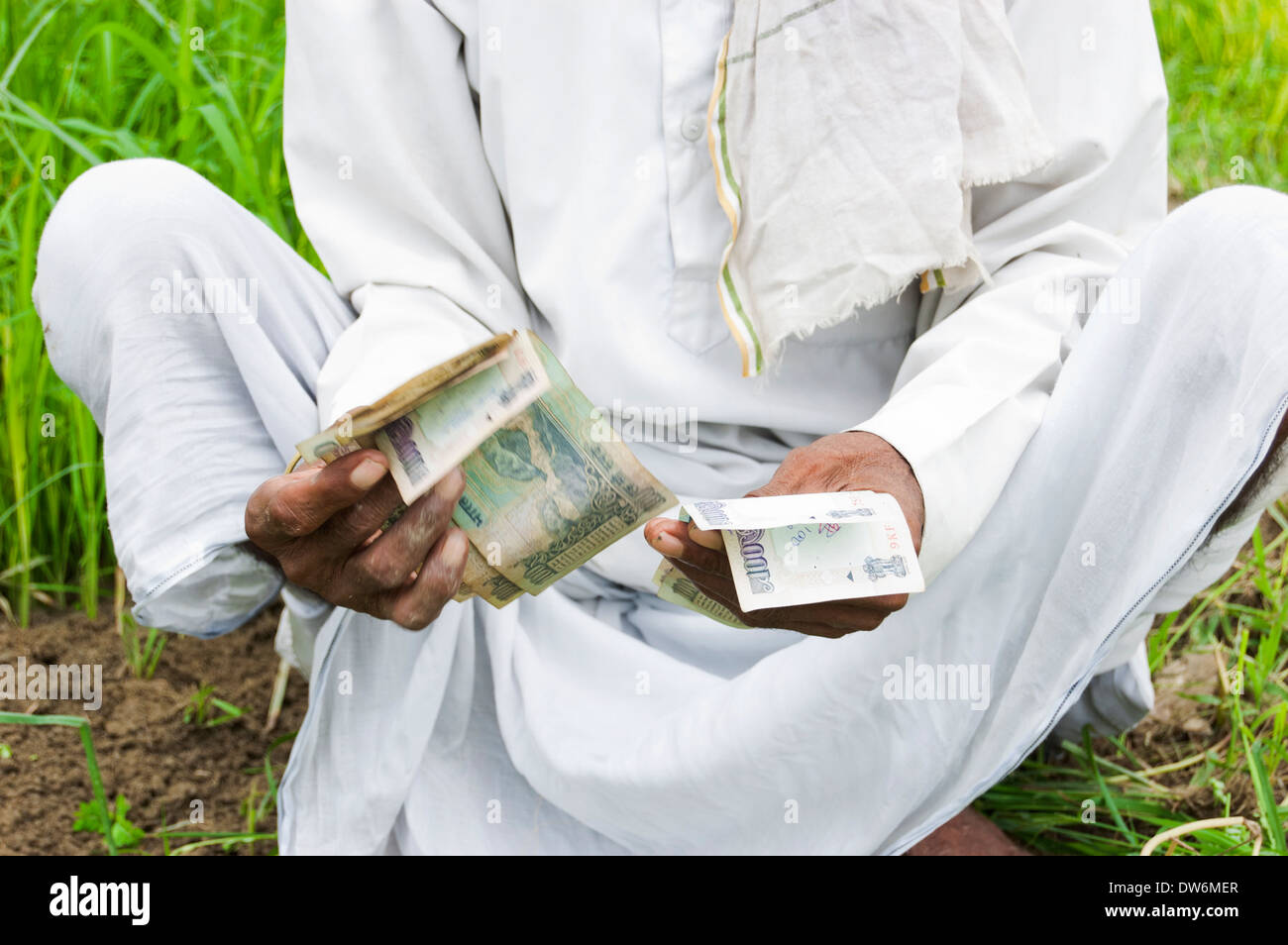 1 Indian farmer sitting and counting rupees Stock Photo - Alamy