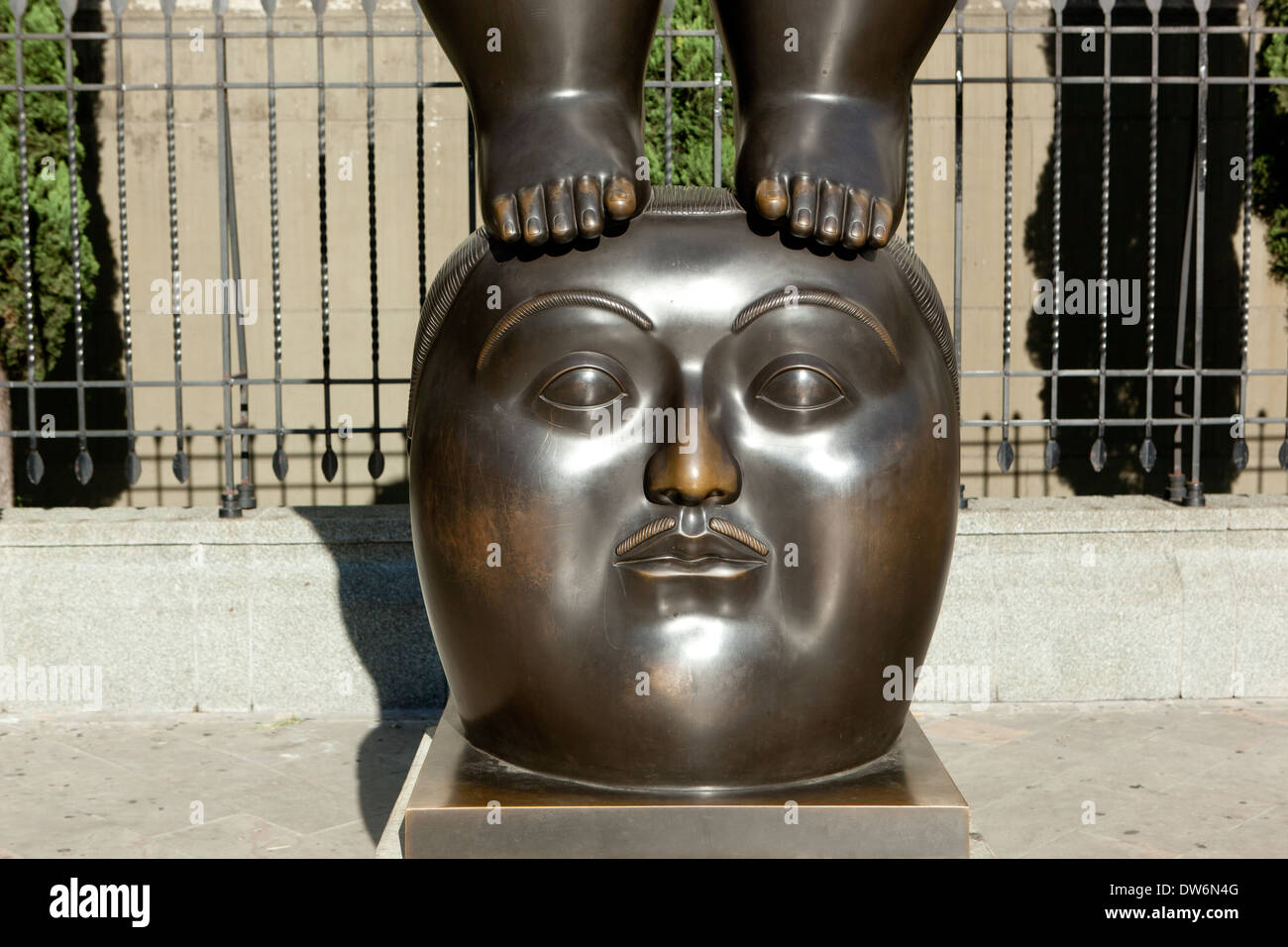 Colombia Medellin A bronze sculpture of feet standing on a head in the ...
