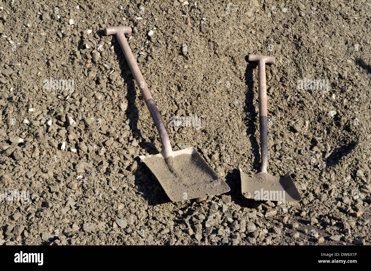 Two spades resting in the sun Stock Photo - Alamy