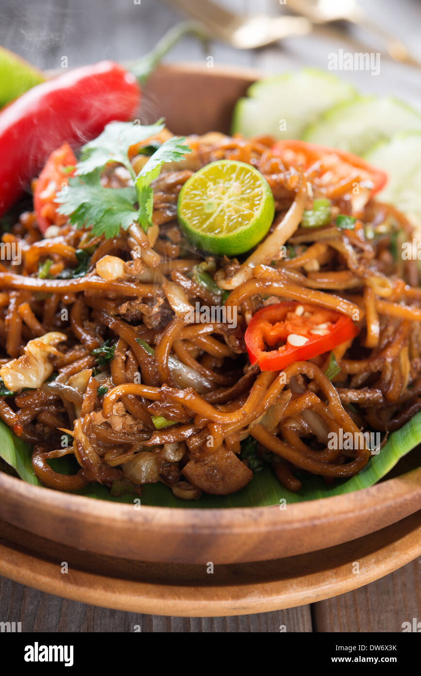 Indonesian and Malaysian cuisine, mi goreng or mee goreng mamak, spicy fried noodles with wooden ...
