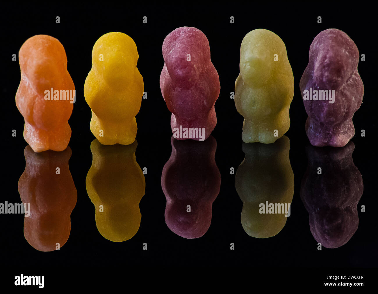 An assortment of 5 different flavoured and coloured jelly babies on a ...