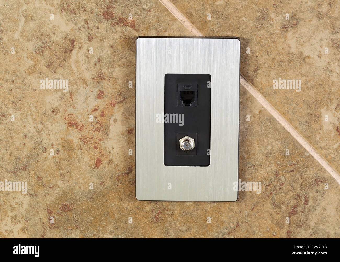 Horizontal photo of a phone jack and cable outlet on tiled wall Stock ...