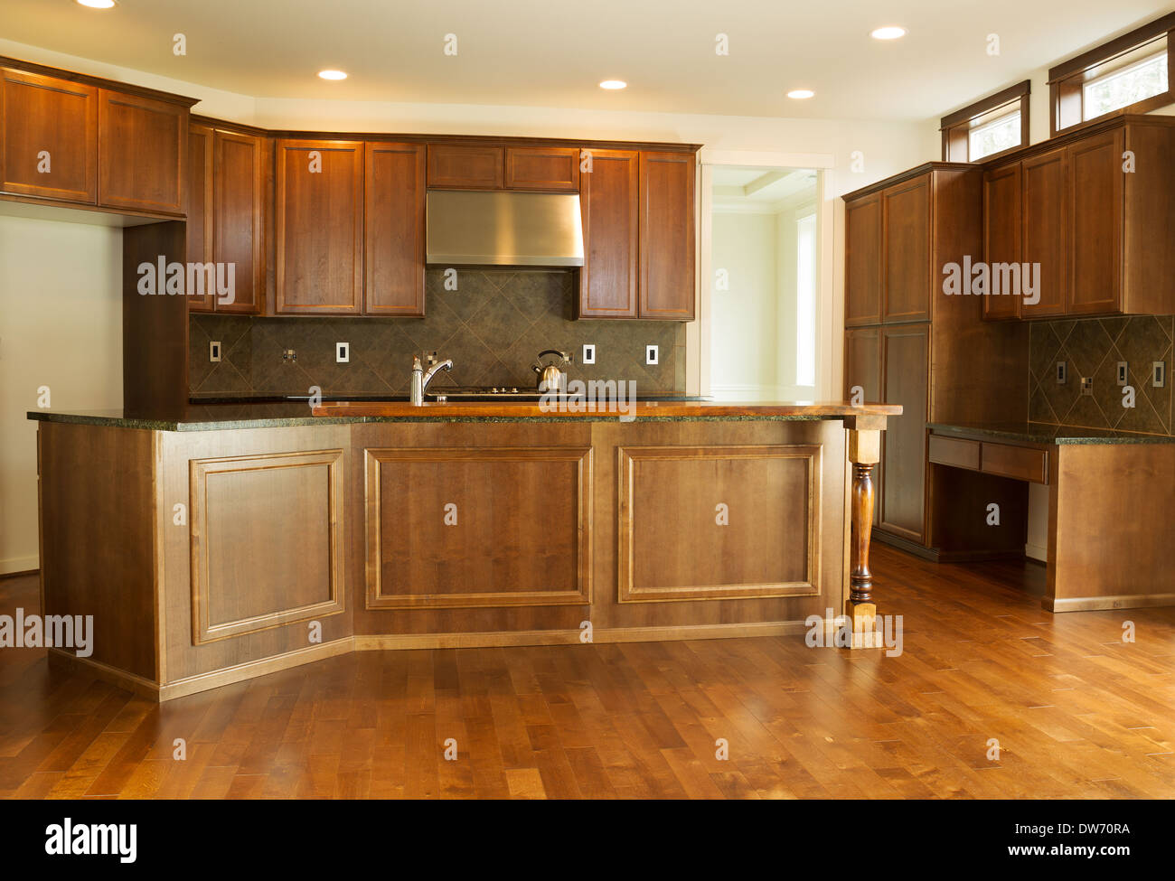 Horizontal photo of a new residential kitchen with stone counter tops ...