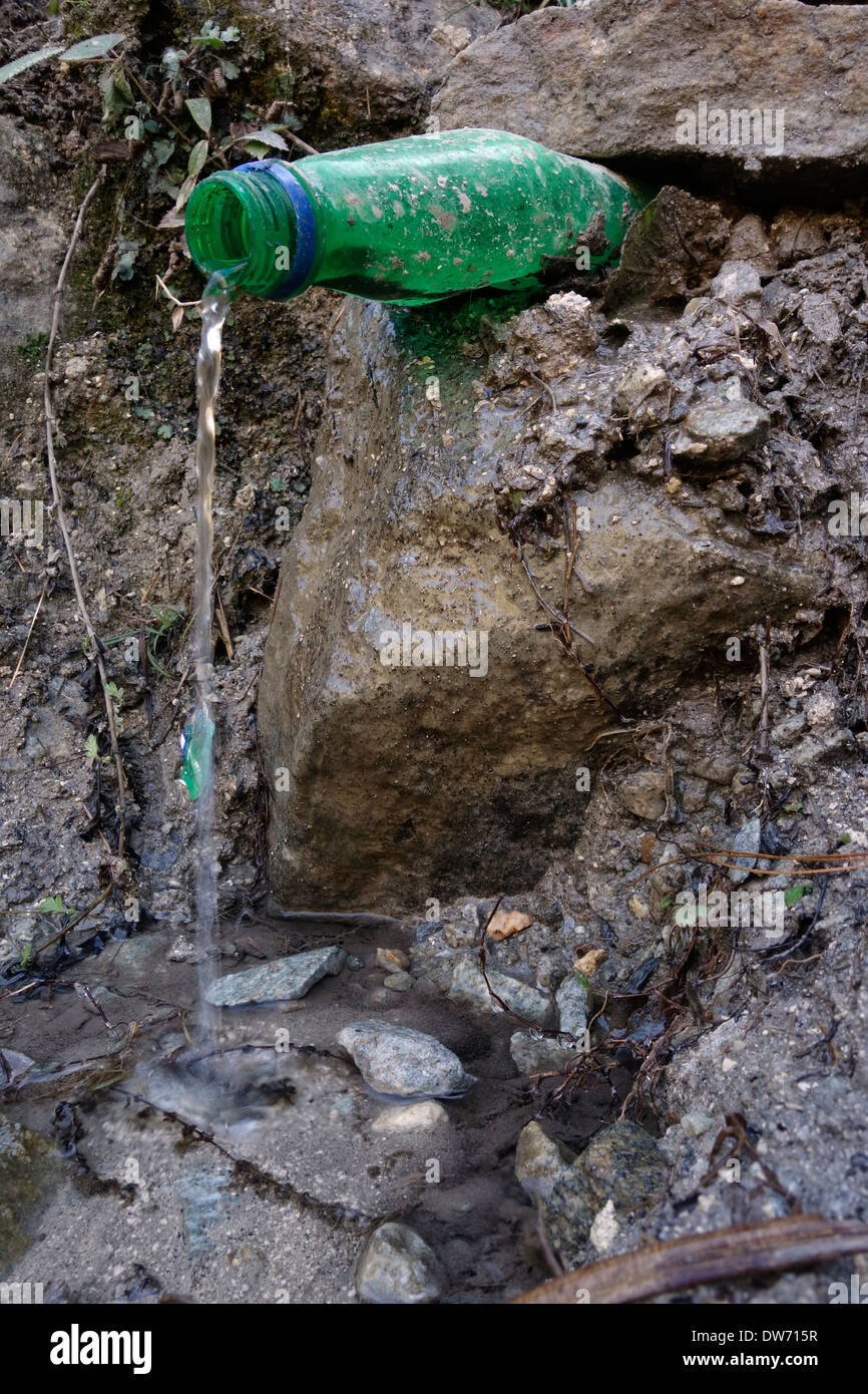 Plastic bottle used to funnel water from a small stream along the ...