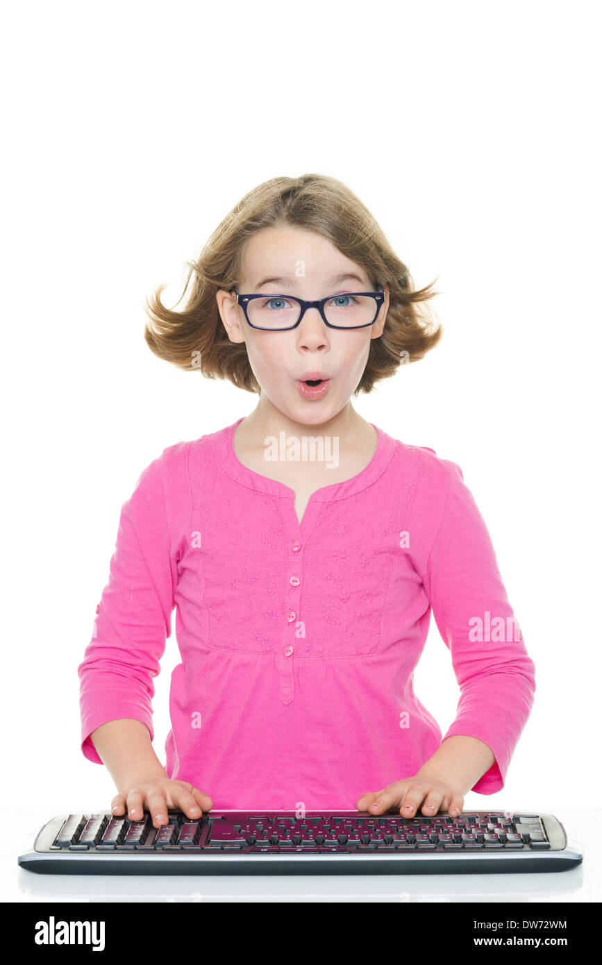 Young girl wondering in front of computer Stock Photo - Alamy