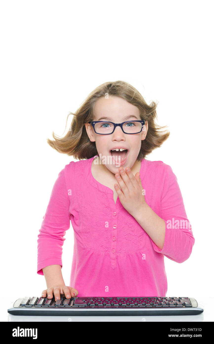 Young girl wondering in front of computer Stock Photo - Alamy
