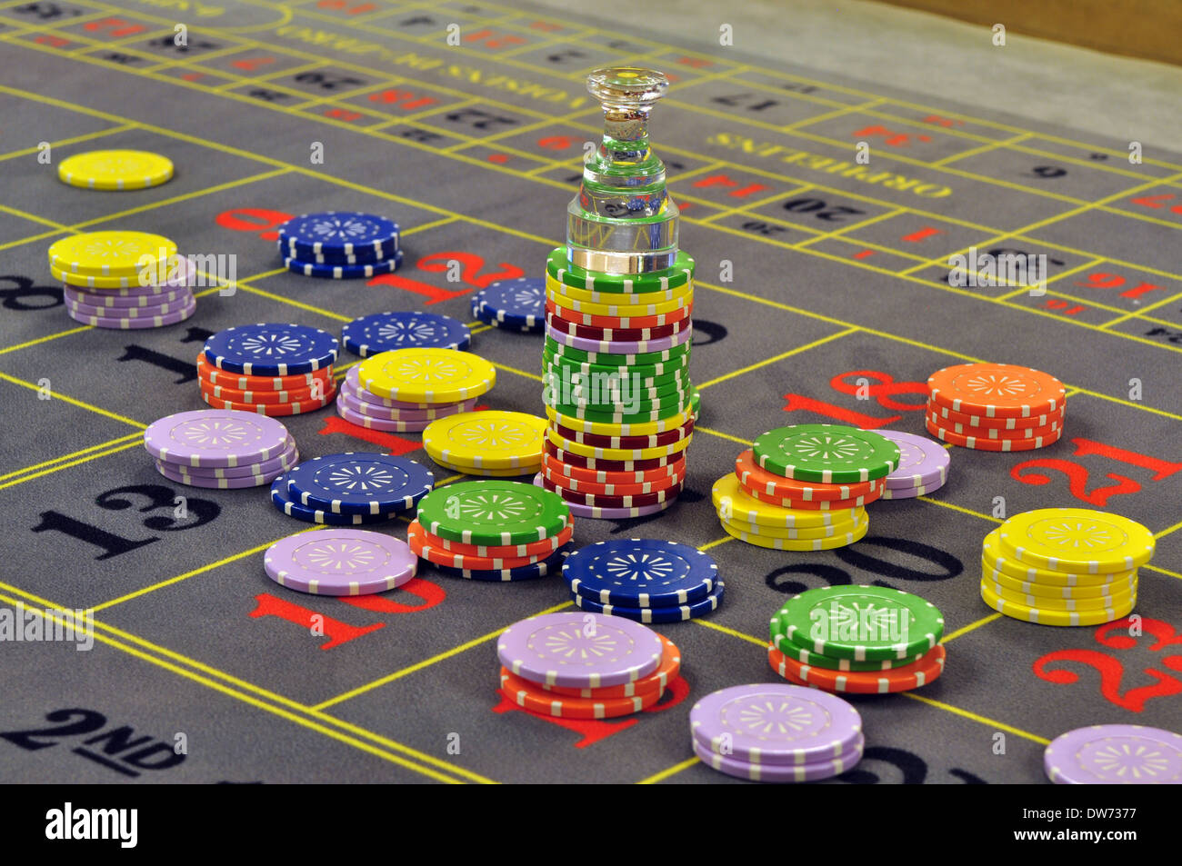 image of a casino roulette gray layout full with chips and the dolly ...