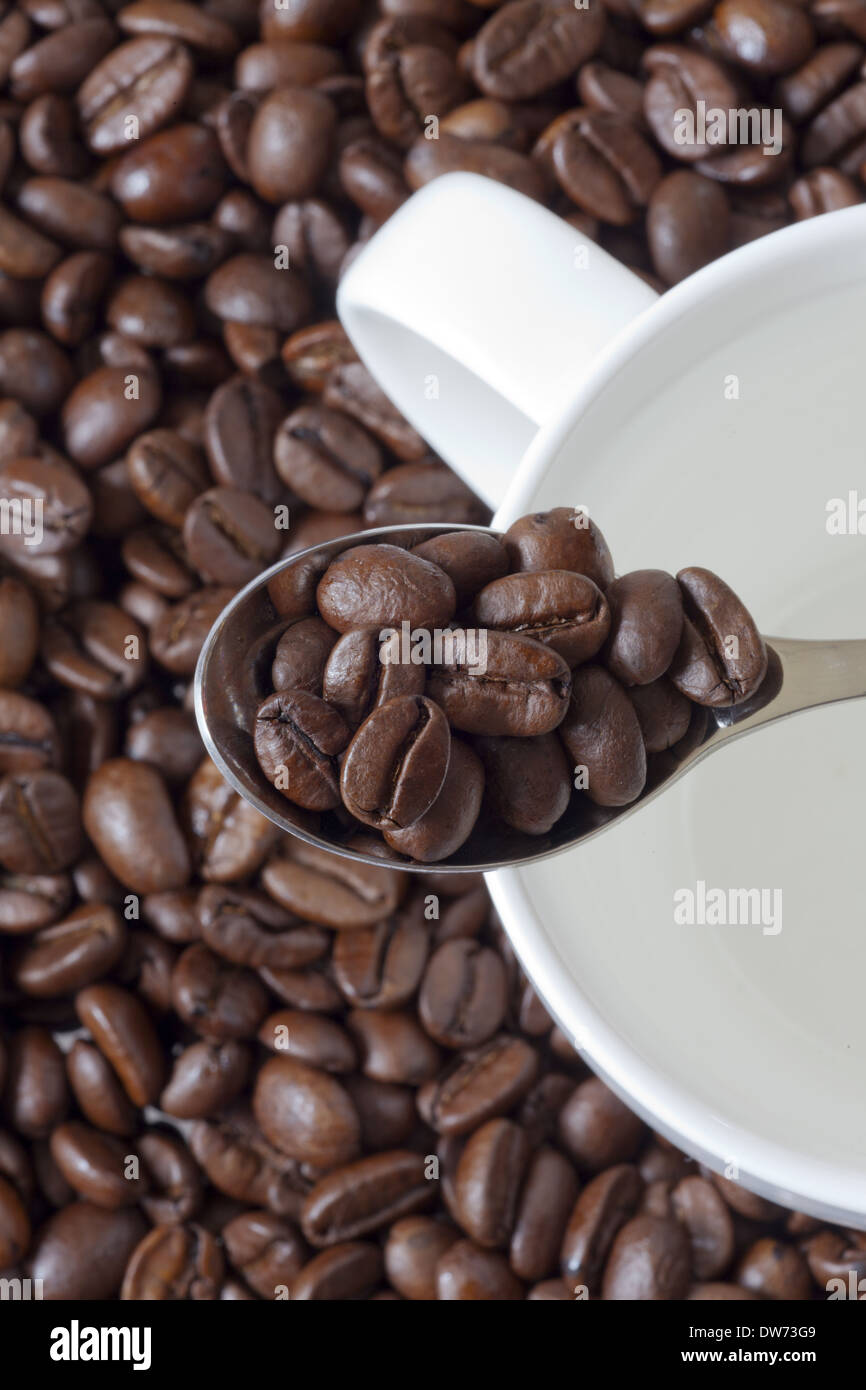 Spoon with Coffee Beans lies on Coffee Cup Stock Photo - Alamy