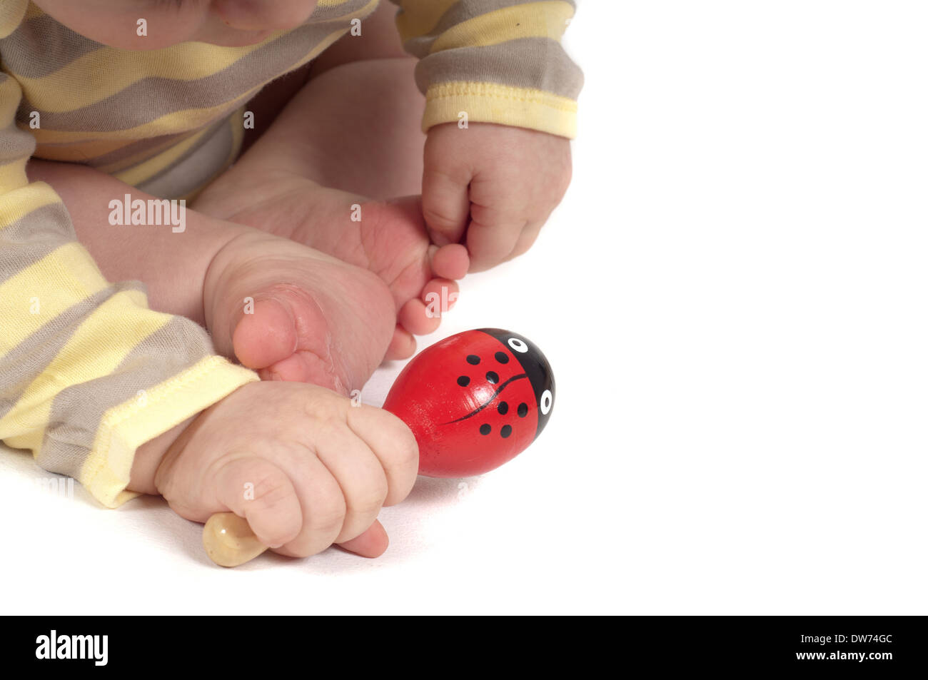 Baby hand with red toy Stock Photo - Alamy