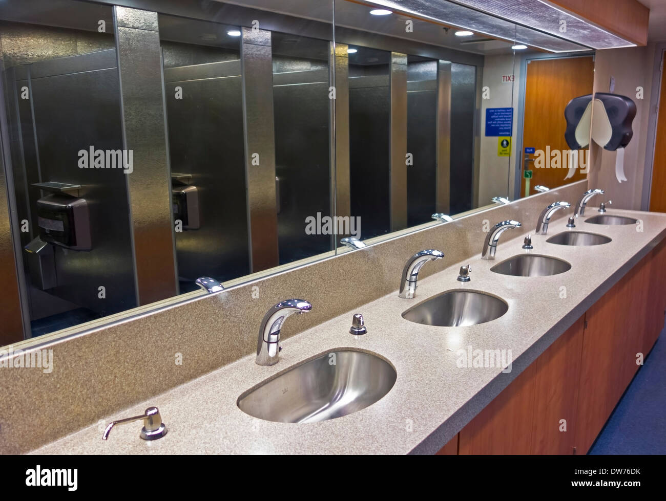 Row of sinks and metal stalls reflecting in the mirrors on a ferry ship ...