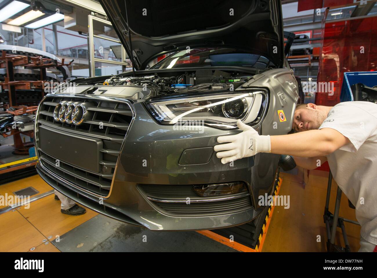 Employees attach a bumper to an Audi A3 at the Audi plant in Ingolstadt ...