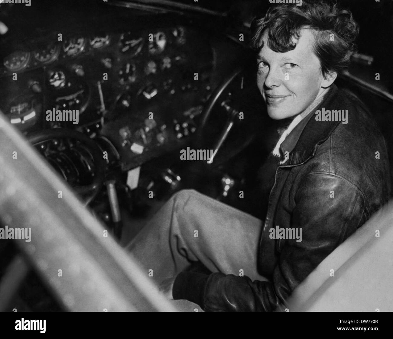 Aviation pioneer Amelia Earhart poses sitting in the cockpit of an ...