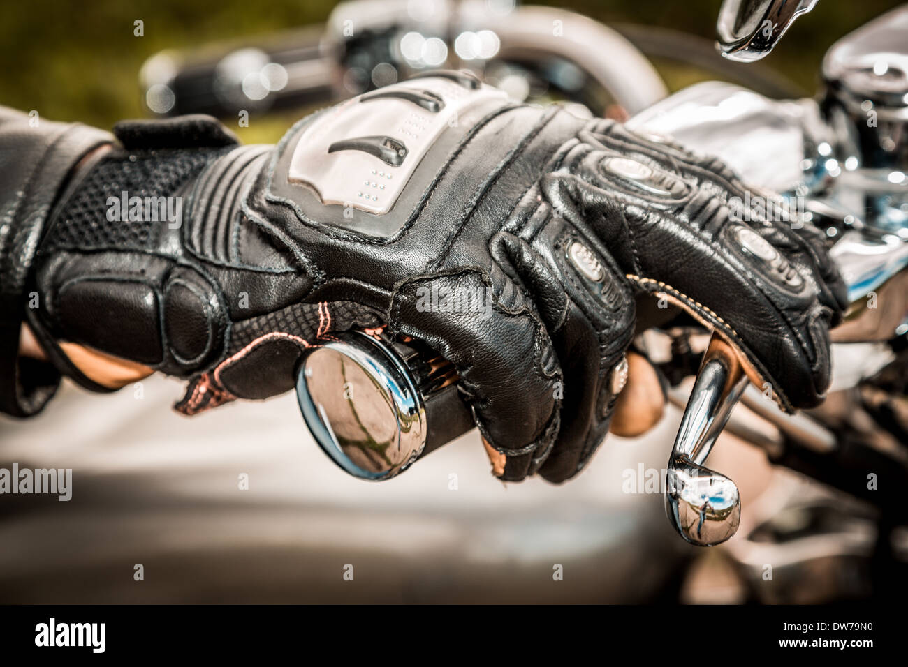 Human hand in a Motorcycle Racing Gloves holds a motorcycle throttle ...