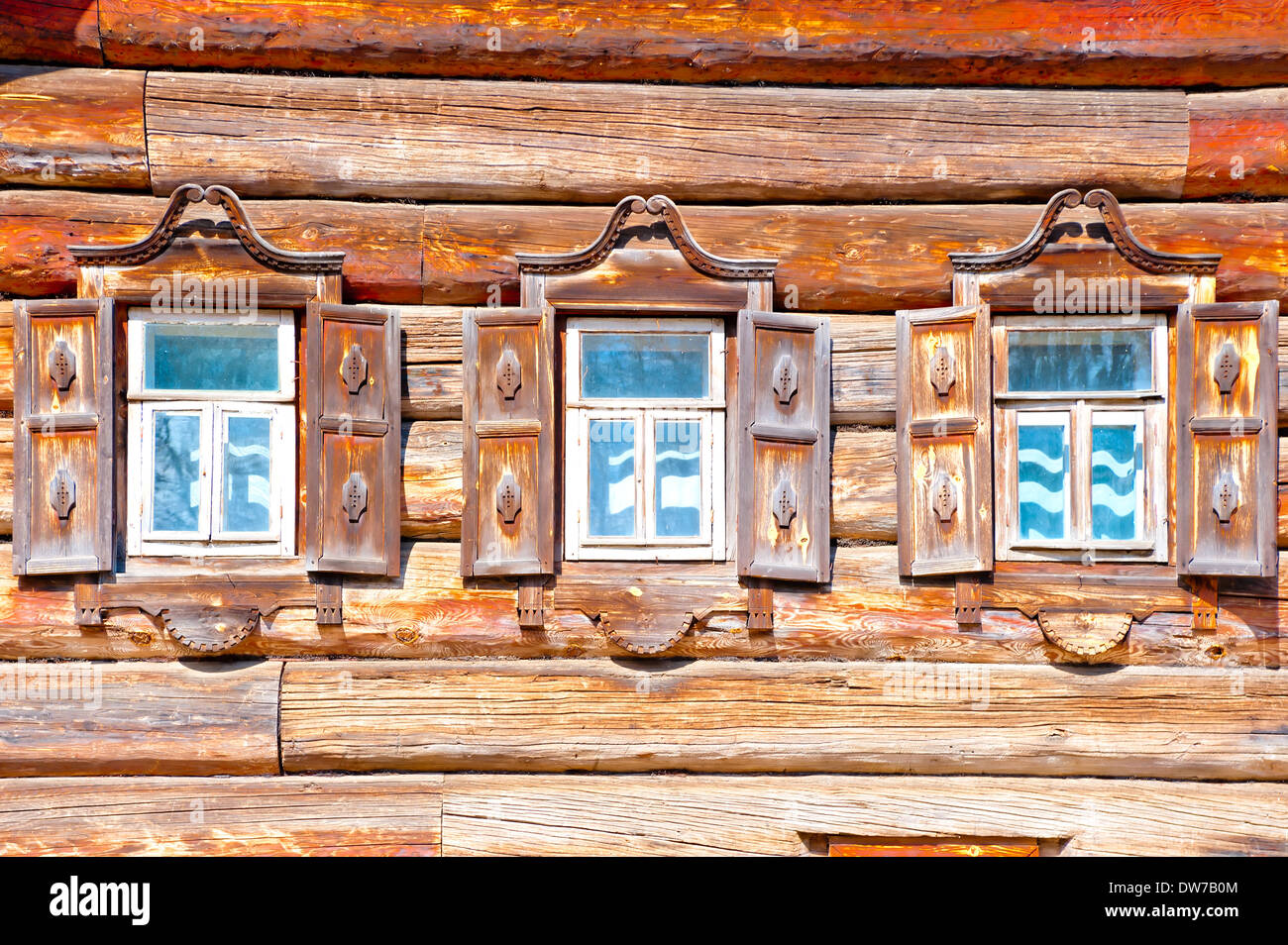 three windows with wooden house of the Russian style Stock Photo - Alamy