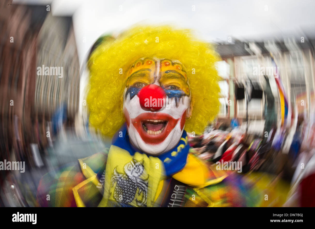 A carnival reveller is dressed as a clown during the carnival parade ...